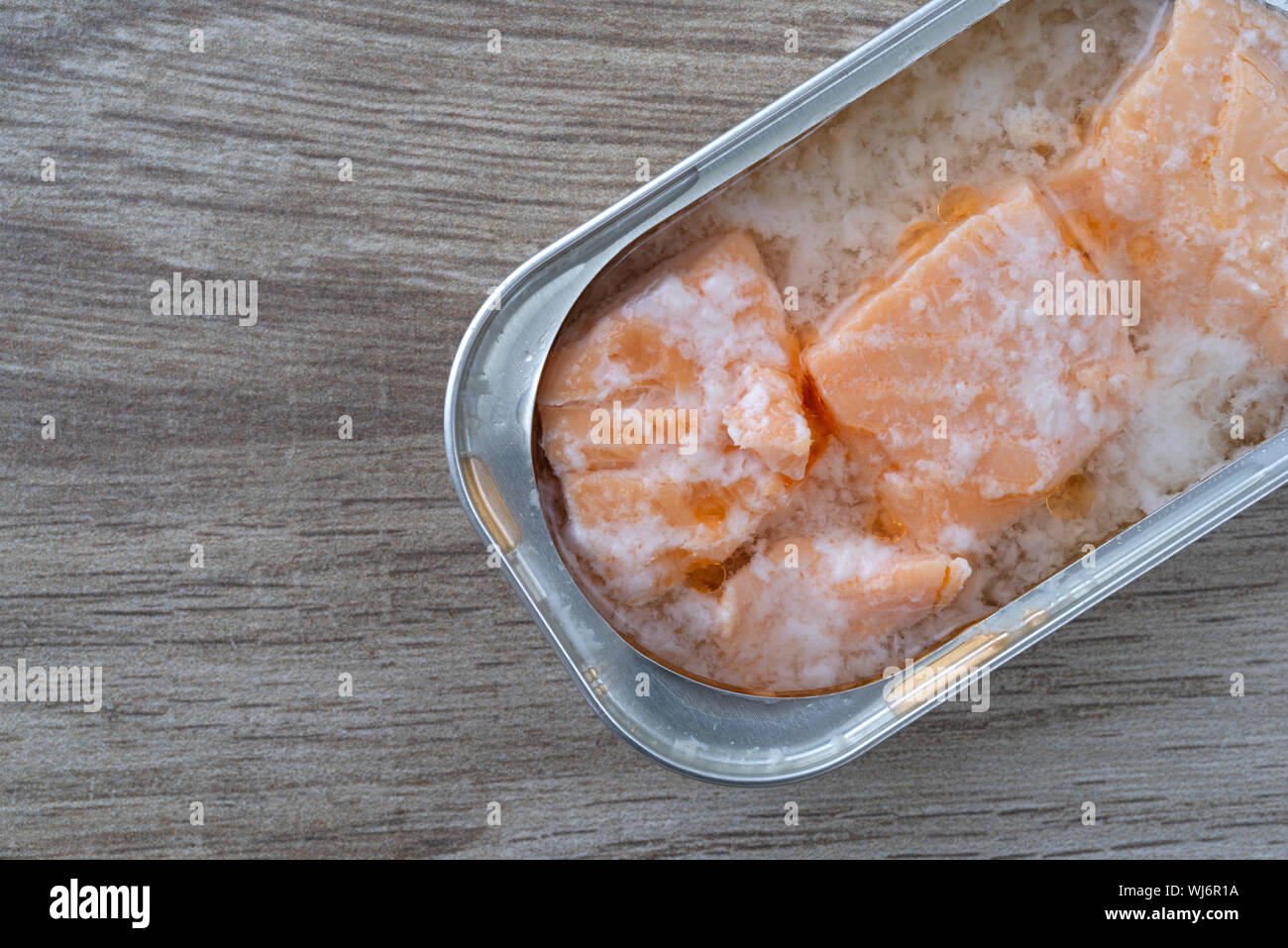 Top view of an open tin of salmon in water isolated on a white ...