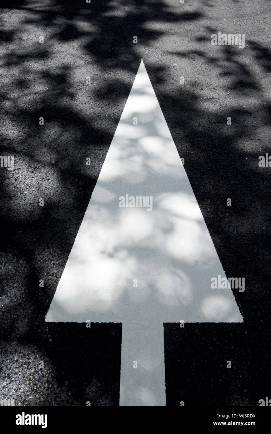 Single arrow directional sign on the floor Stock Photo - Alamy