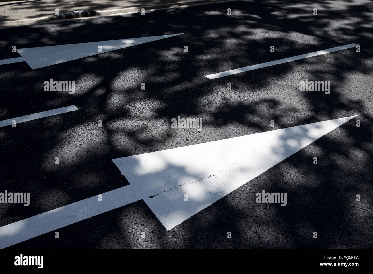 Two arrow directional signals on the floor Stock Photo - Alamy