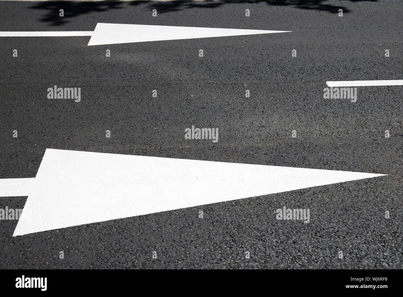 Two arrow directional signals on the floor Stock Photo - Alamy