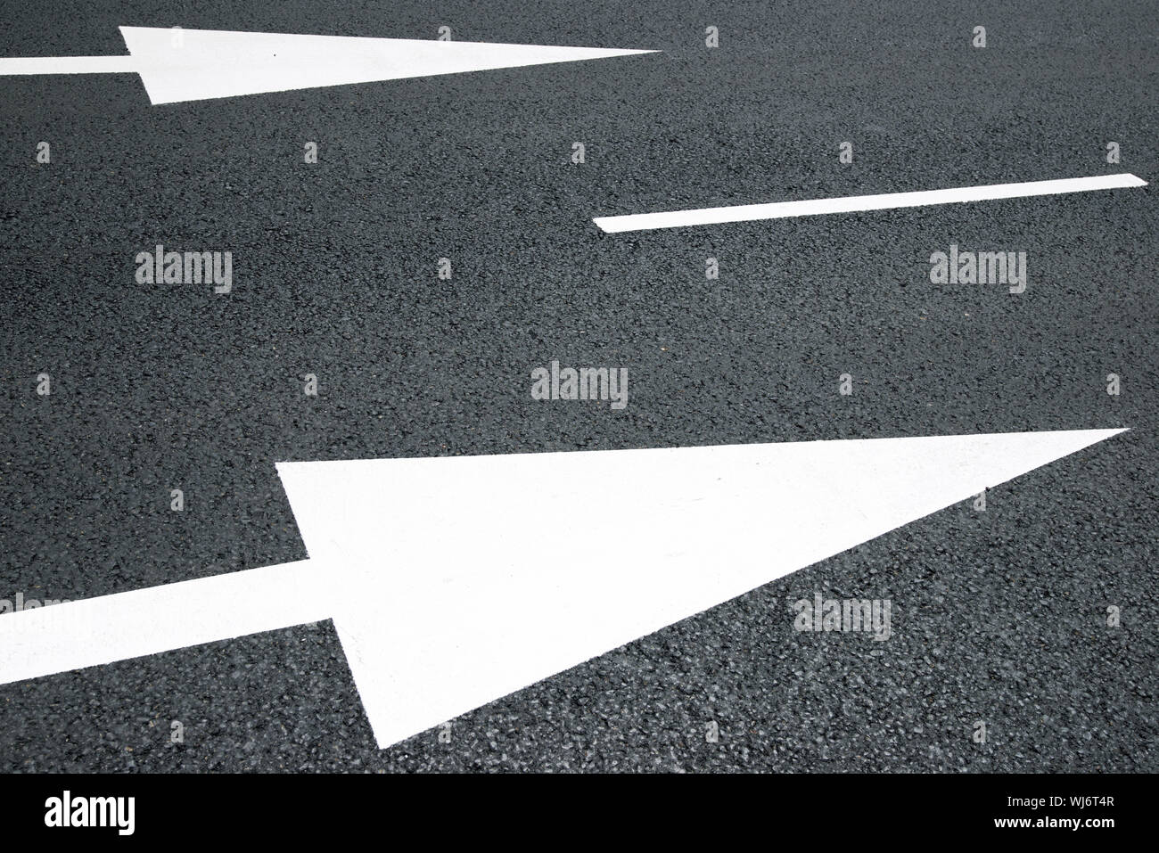 Two arrow directional signals on the floor Stock Photo - Alamy