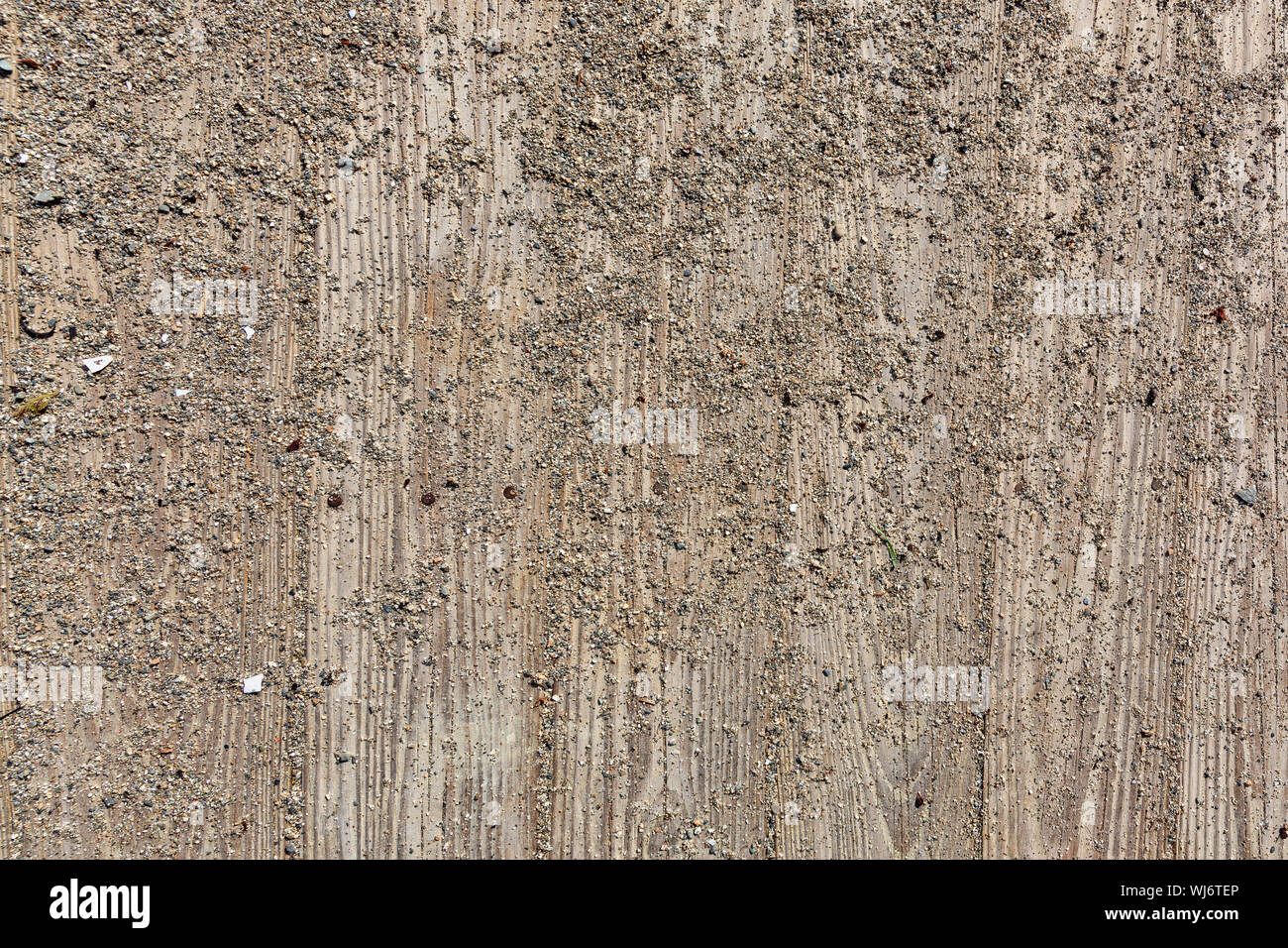 Close view of wood boards of a boardwalk with sand and gravel from foot ...