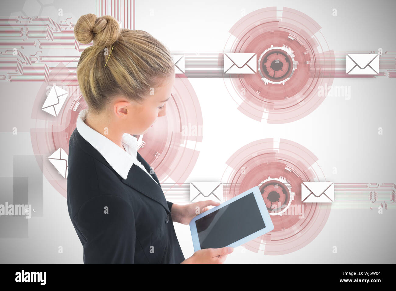 Composite image of blonde businesswoman holding tablet Stock Photo - Alamy