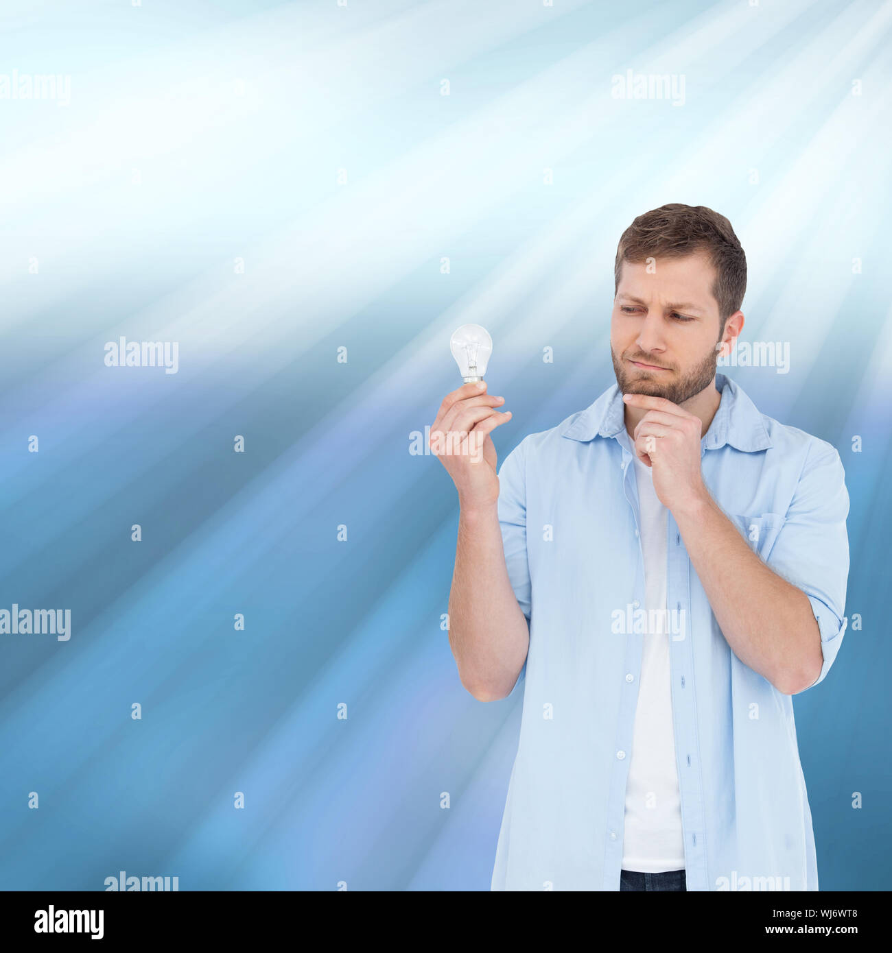 Composite image of sceptical model on white background holding a bulb ...