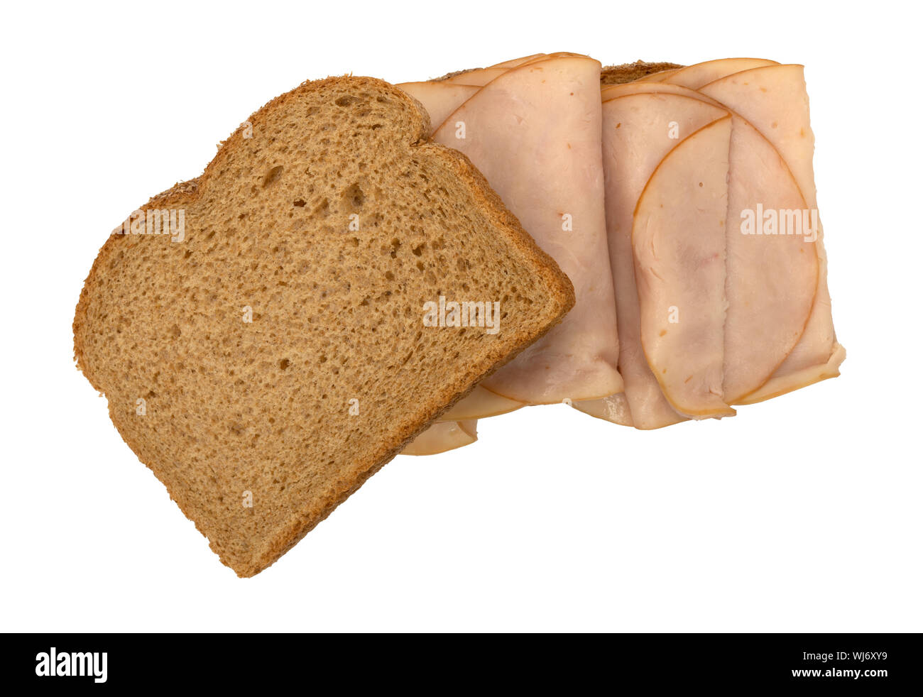 Top view of a sandwich with thin sliced smoked turkey on wheat bread ...