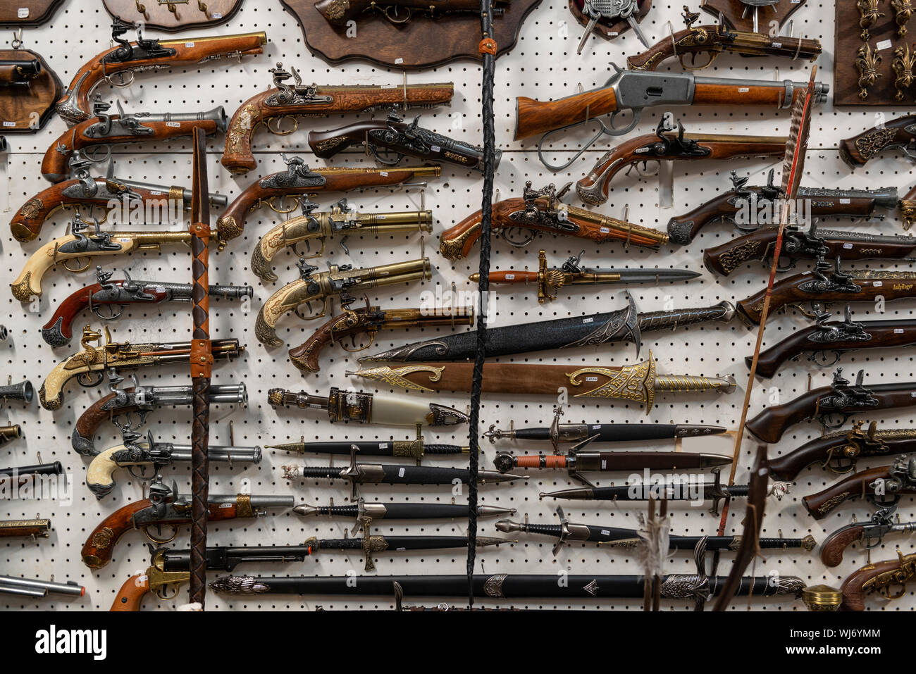 Set of old eapon on the souvenir shop shelves. Pistols, swords and ...