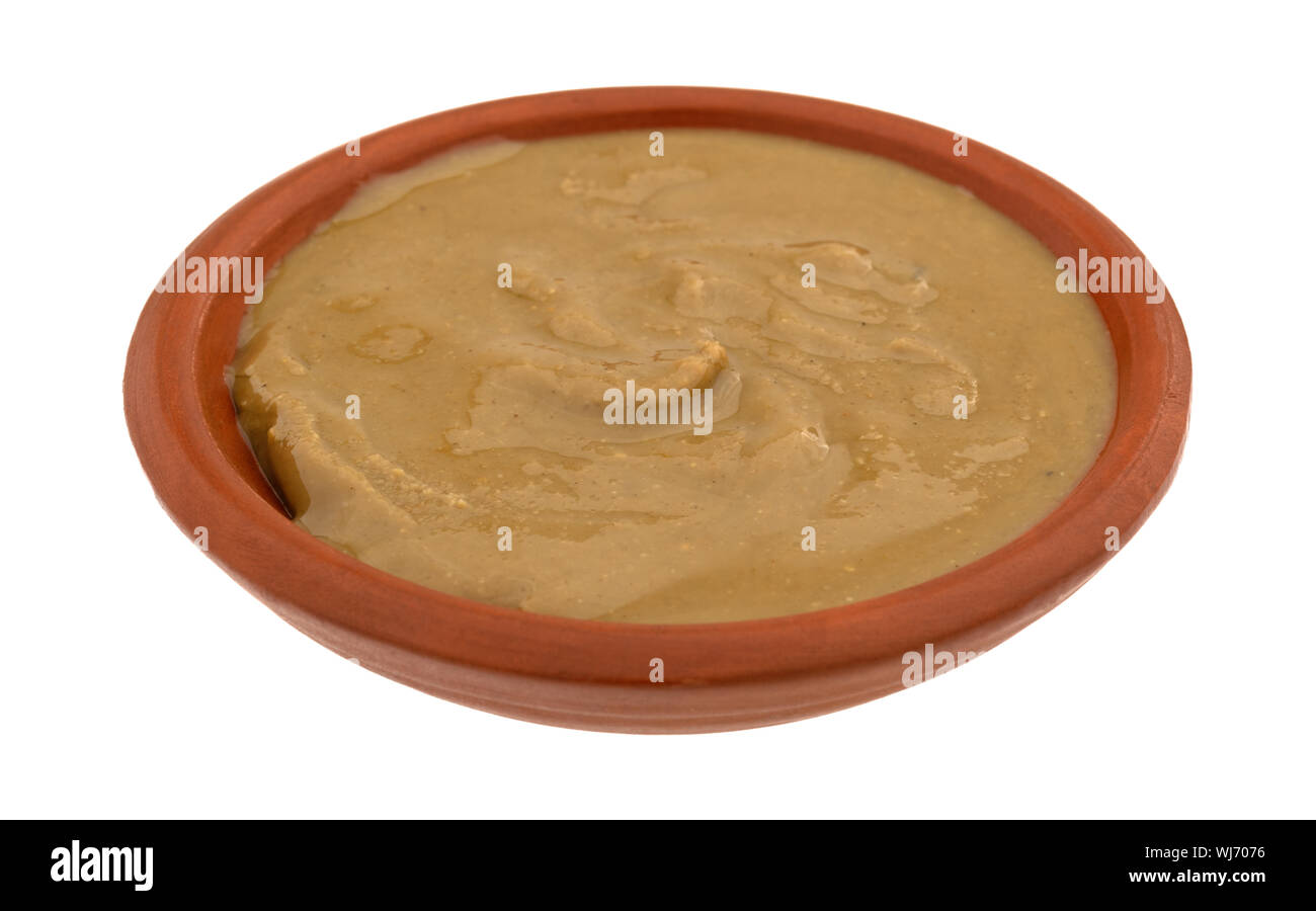 Side view of organic sunflower seed butter in a small bowl isolated on ...