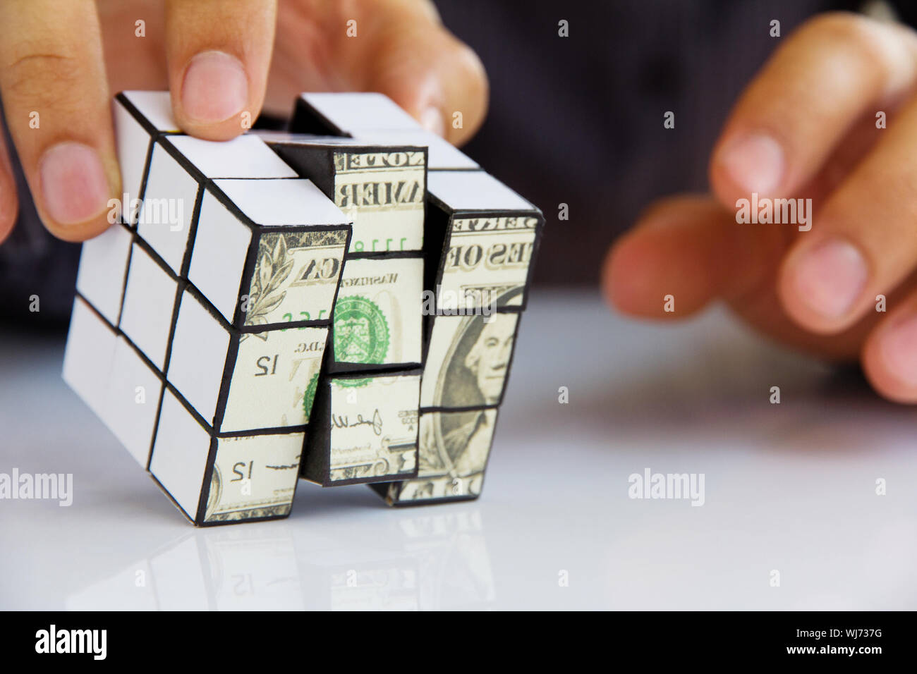 business man hand holding a rubik's cube,money concept Stock Photo - Alamy