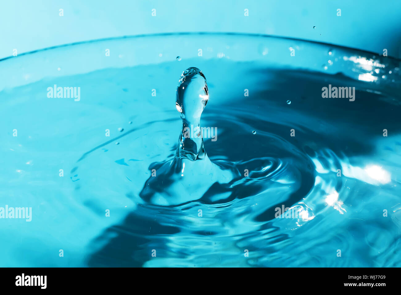 Water splash close-up. Drop of water. Blue water drop. Falling water ...