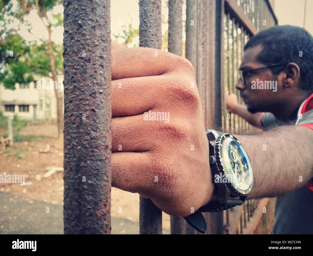 Man holding metal gate hi-res stock photography and images - Alamy