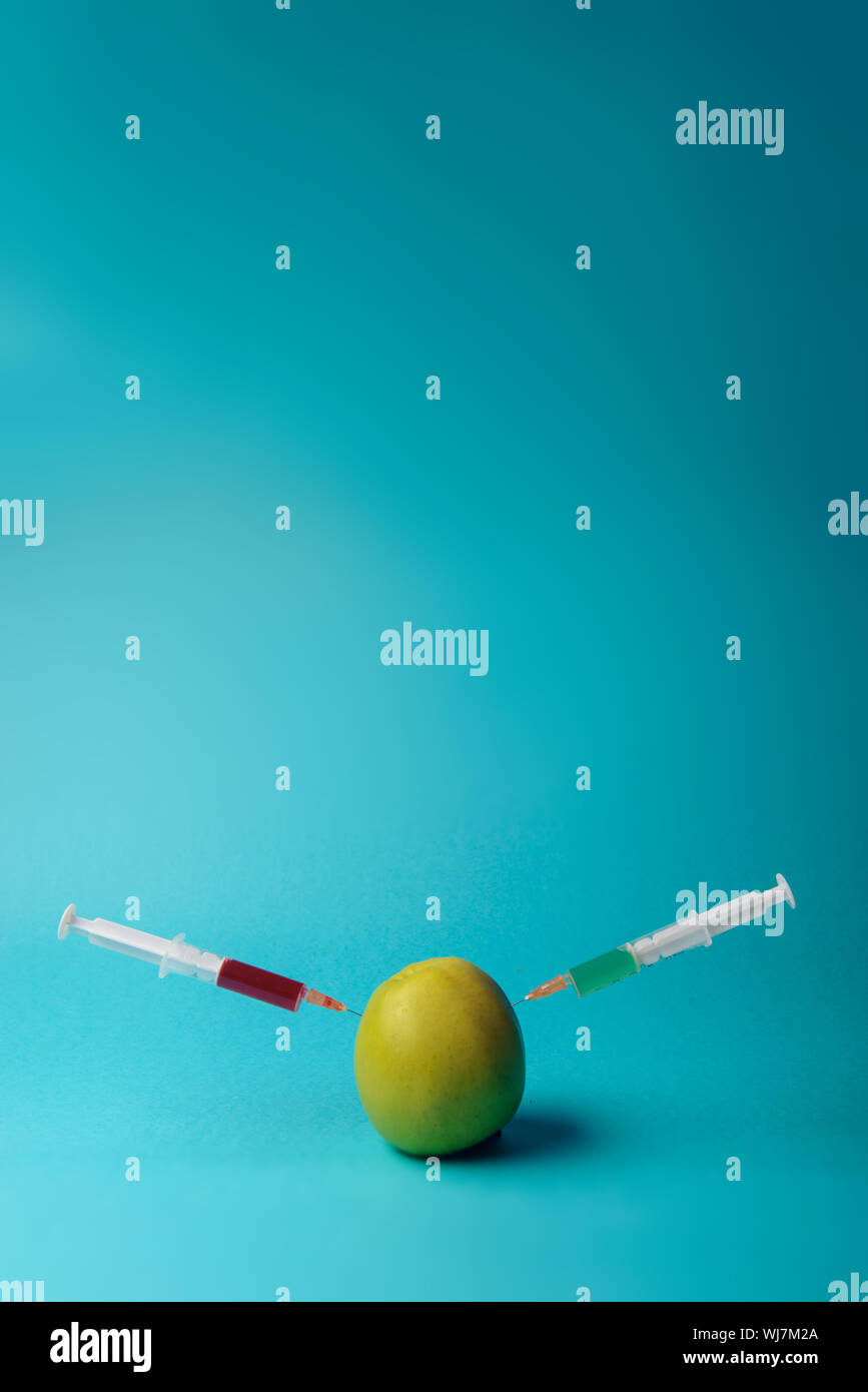 Chemical additives in food or genetically modified fruit concept. Green ...