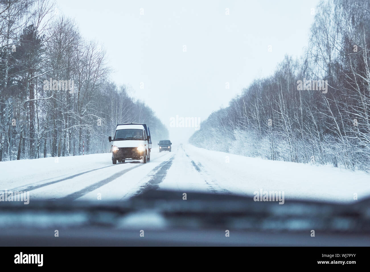 Back view of car on snowy winter road Stock Photo - Alamy