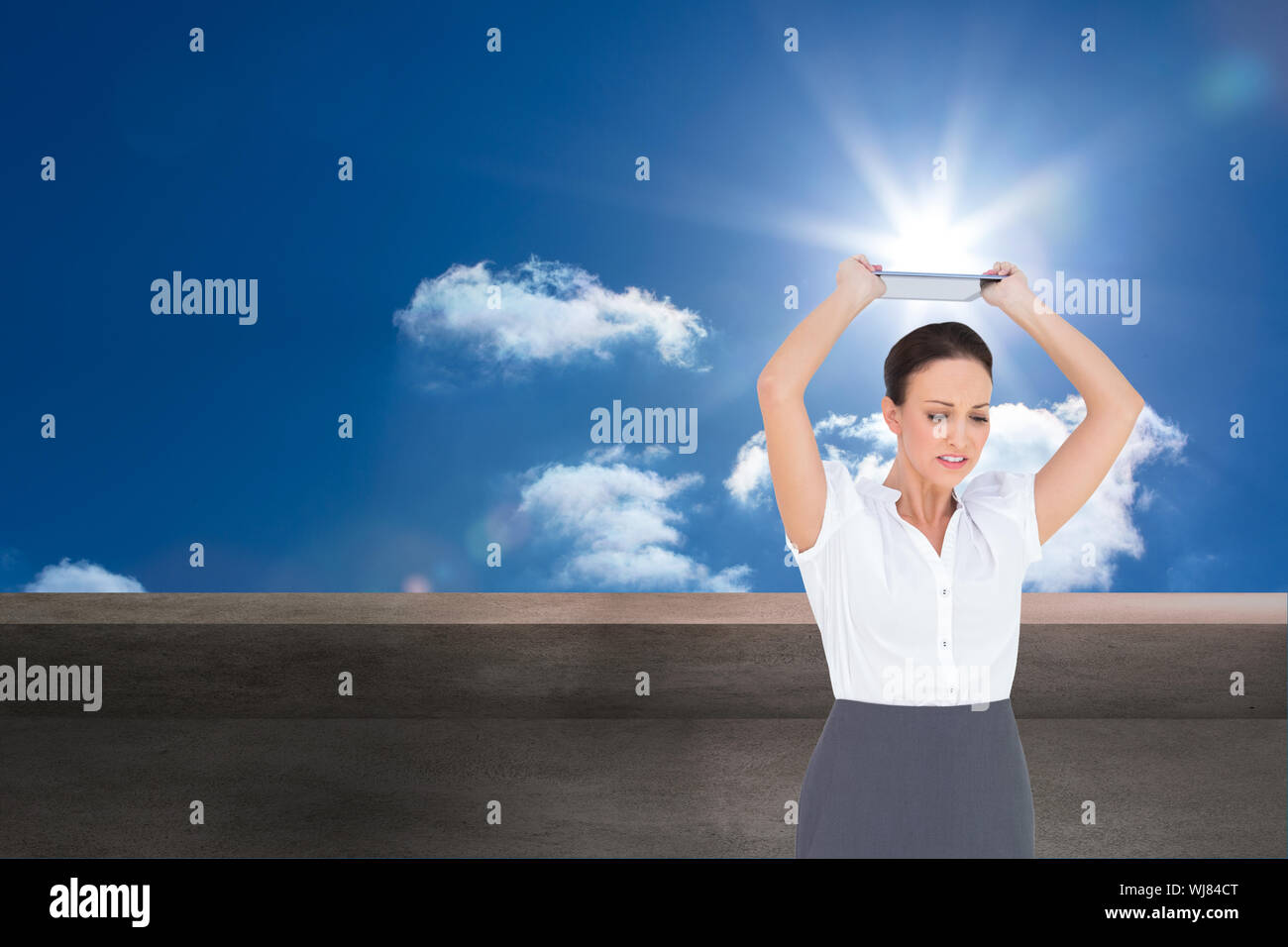 Composite image of angry businesswoman throwing her tablet pc while ...