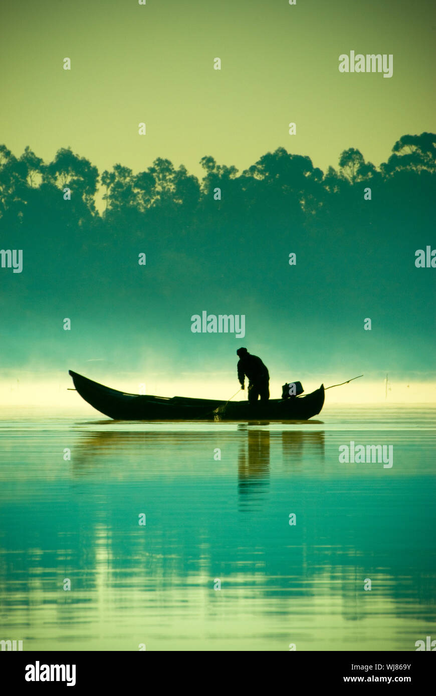 The boatman fishing on a lake Stock Photo - Alamy