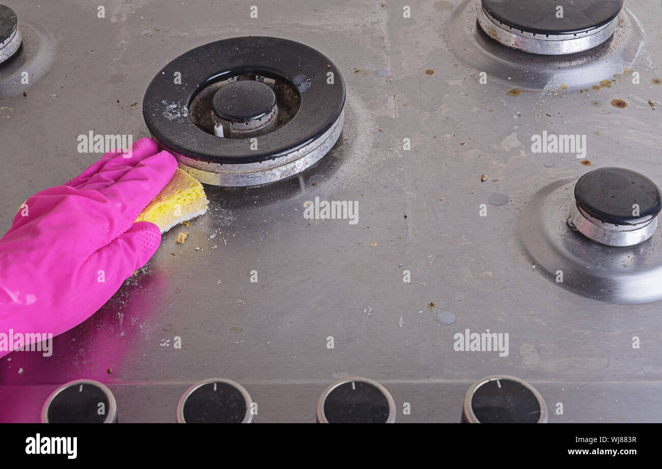 Manual Cleaning of stainless steel gas stove with scrub and sponge ...