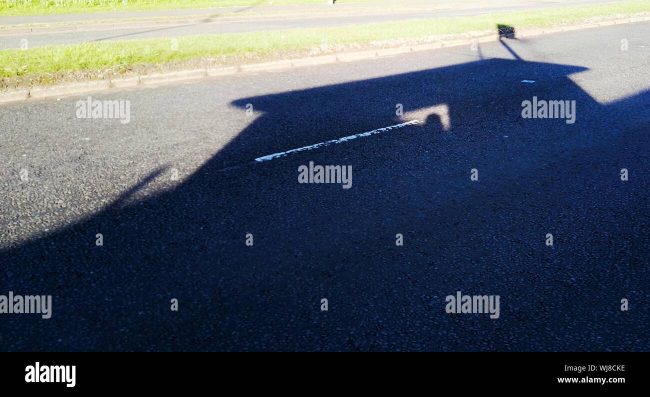 Shadow Of Bus Stop On Street Stock Photo - Alamy