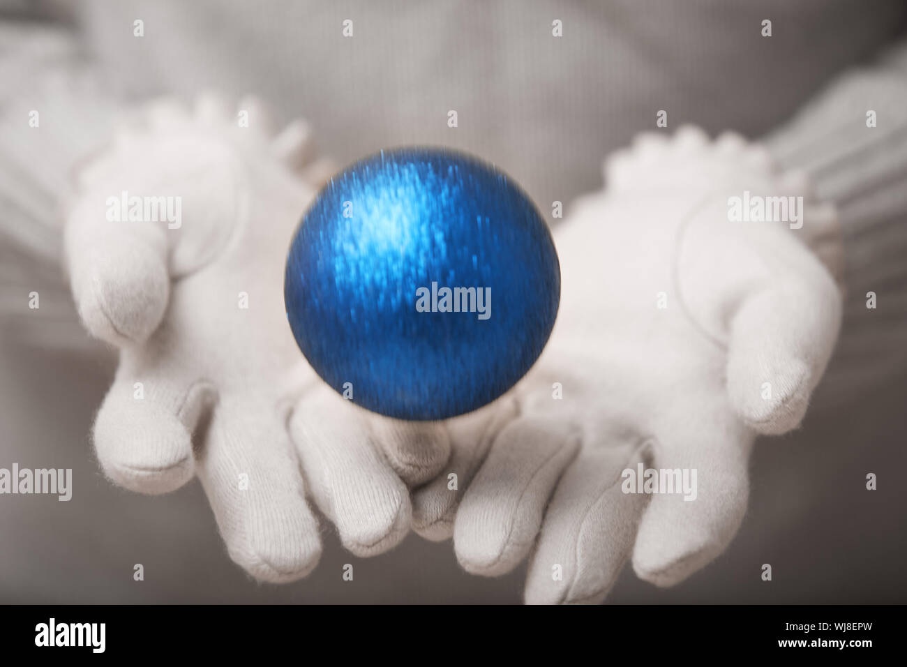 Human hands in warm mittens throwing Christmas ball Stock Photo - Alamy