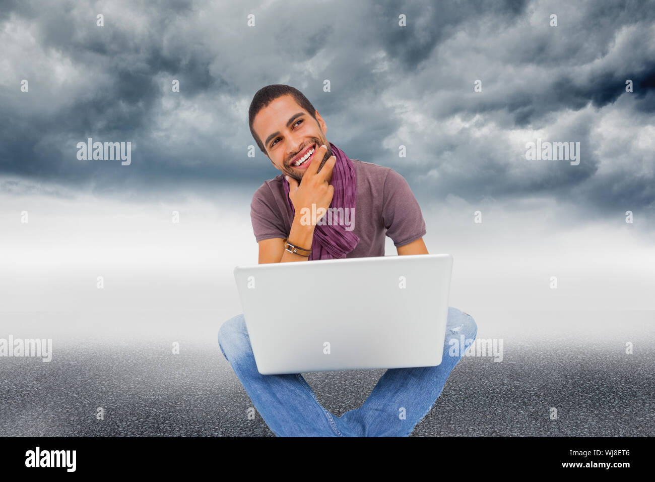 Composite image of thinking man sitting on floor using laptop and ...
