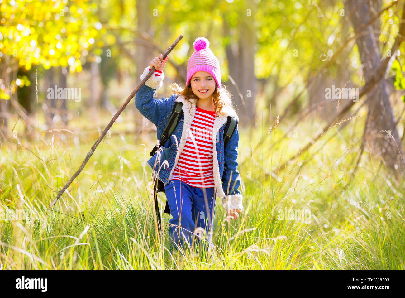 Hiking kid girl with backpack in autum poplar trees forest and walking ...
