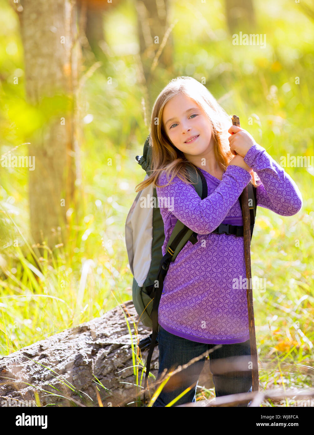 Hiking kid girl with backpack in autum poplar trees forest and walking ...