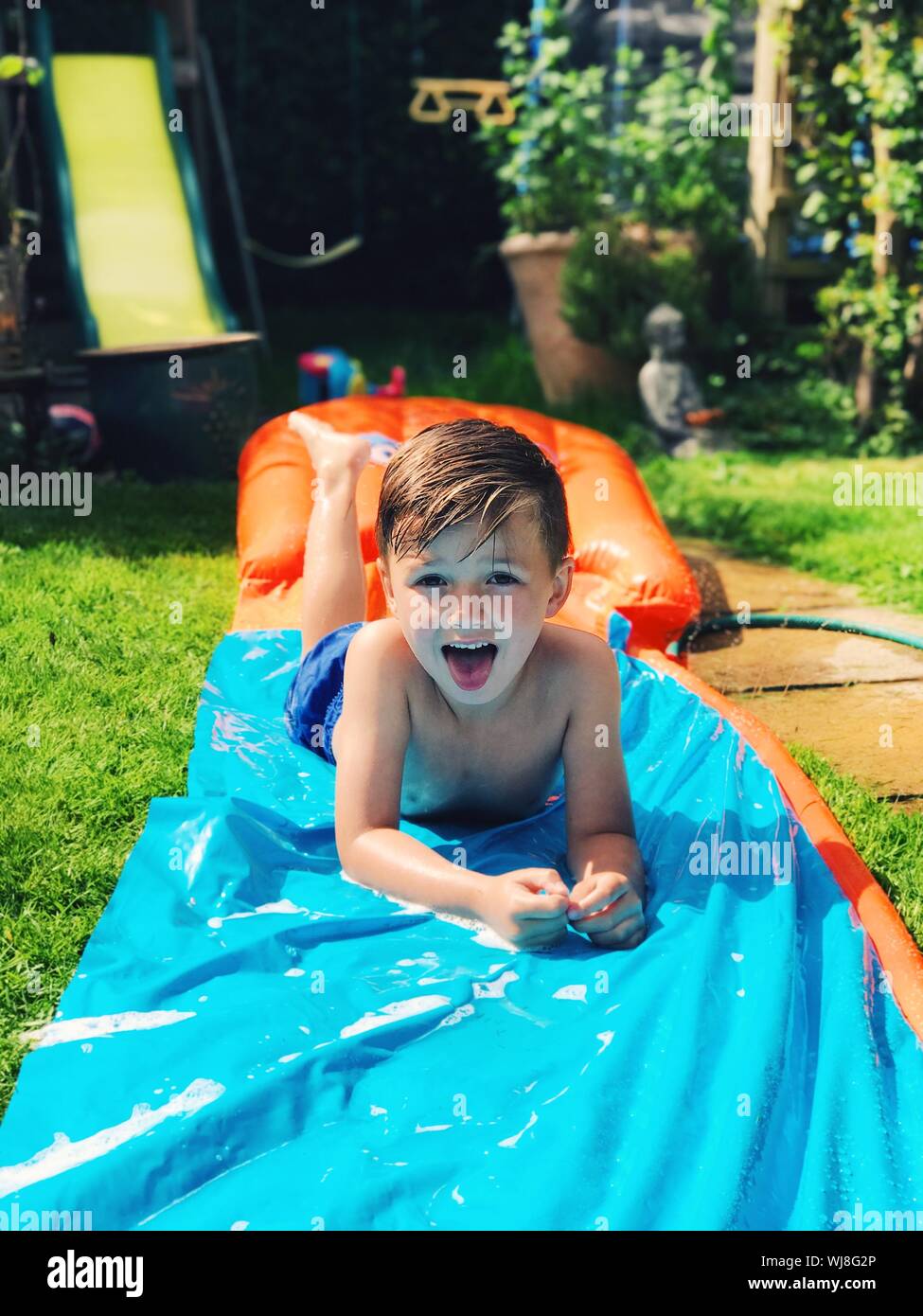 Boy water slide hi-res stock photography and images - Alamy