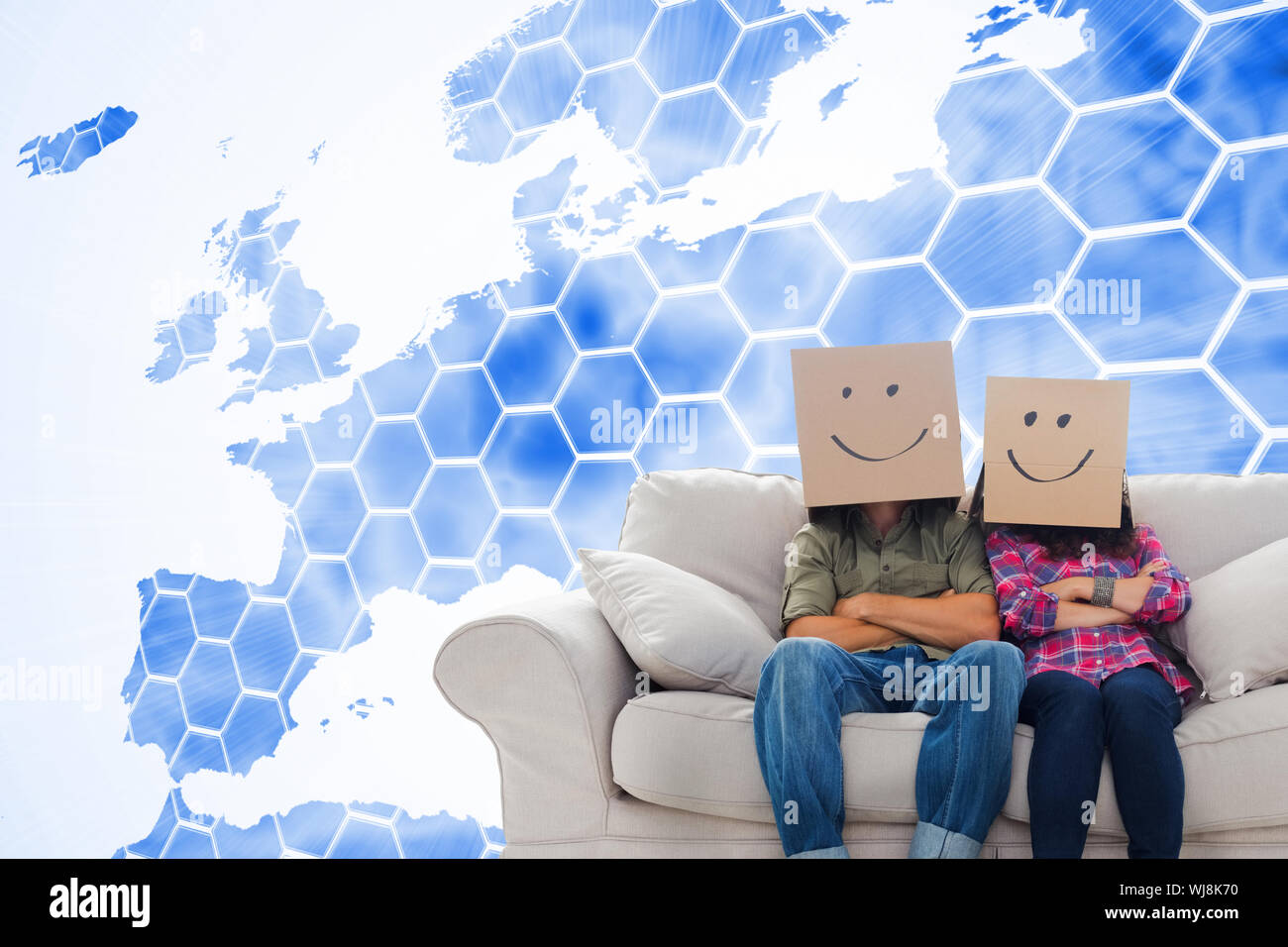 Composite image of silly employees with arms folded wearing boxes on ...