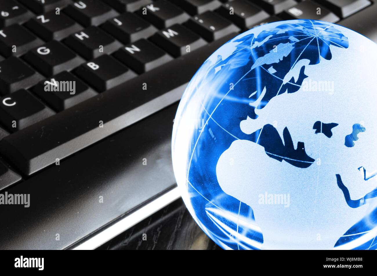 globe and keyboard showing global communication or internet concept ...