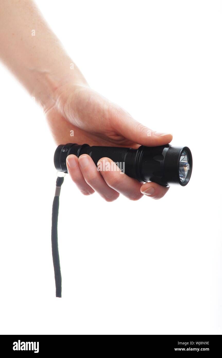 hand holding flashlight isolated on a white background Stock Photo - Alamy