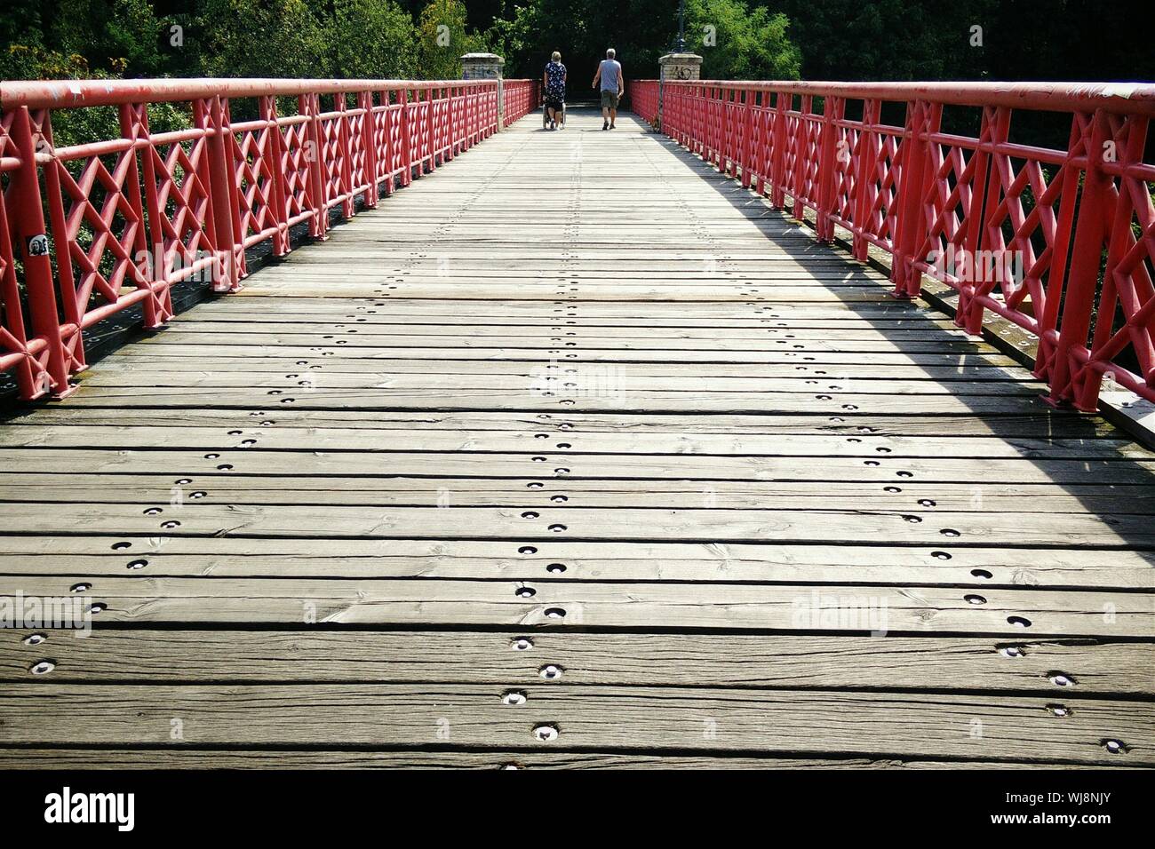Rear View Of People Walking On Bridge Stock Photo - Alamy