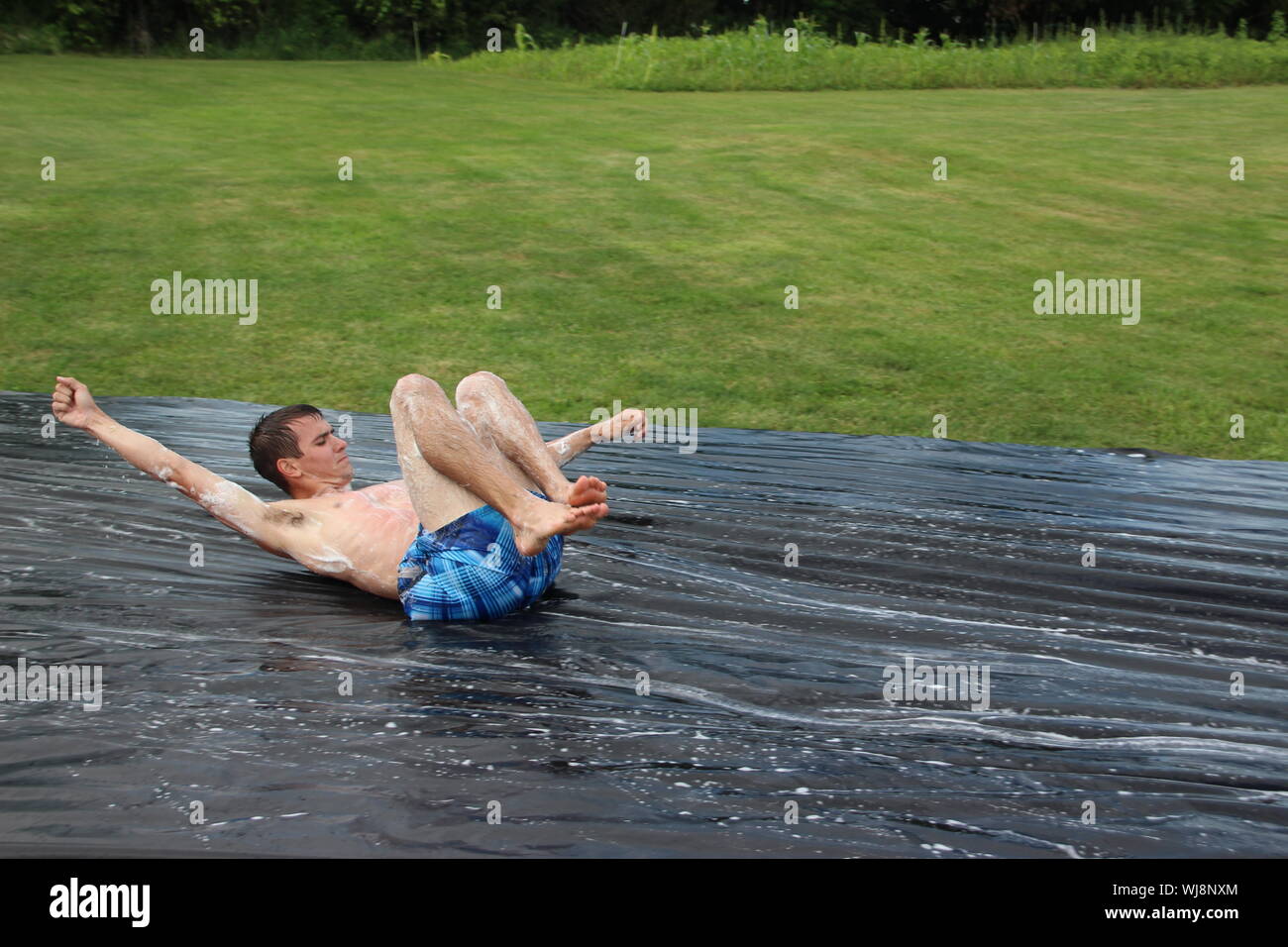 Man water slide hi-res stock photography and images - Alamy