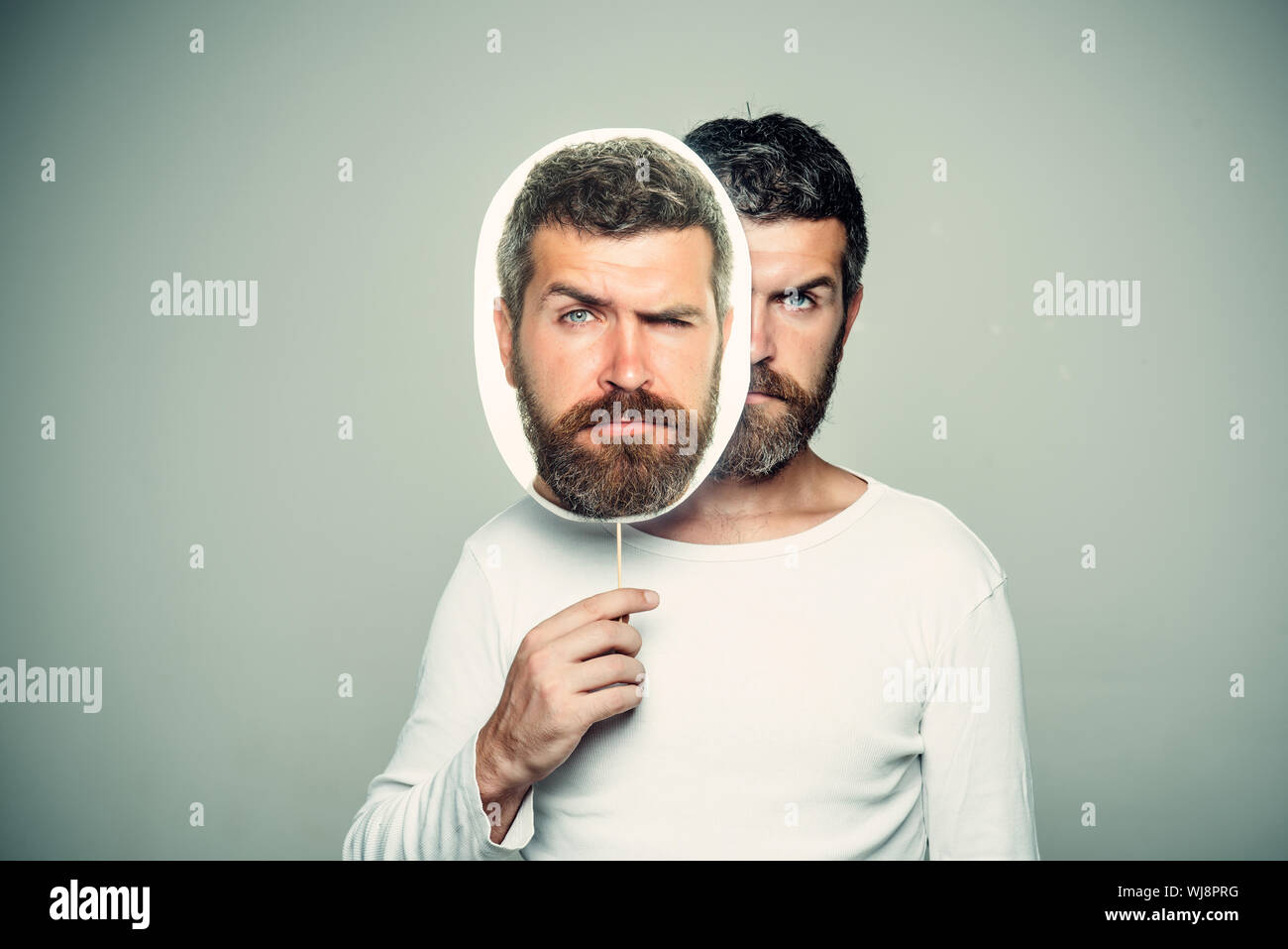 man with long beard on sad face hold paper nameplate Stock Photo - Alamy
