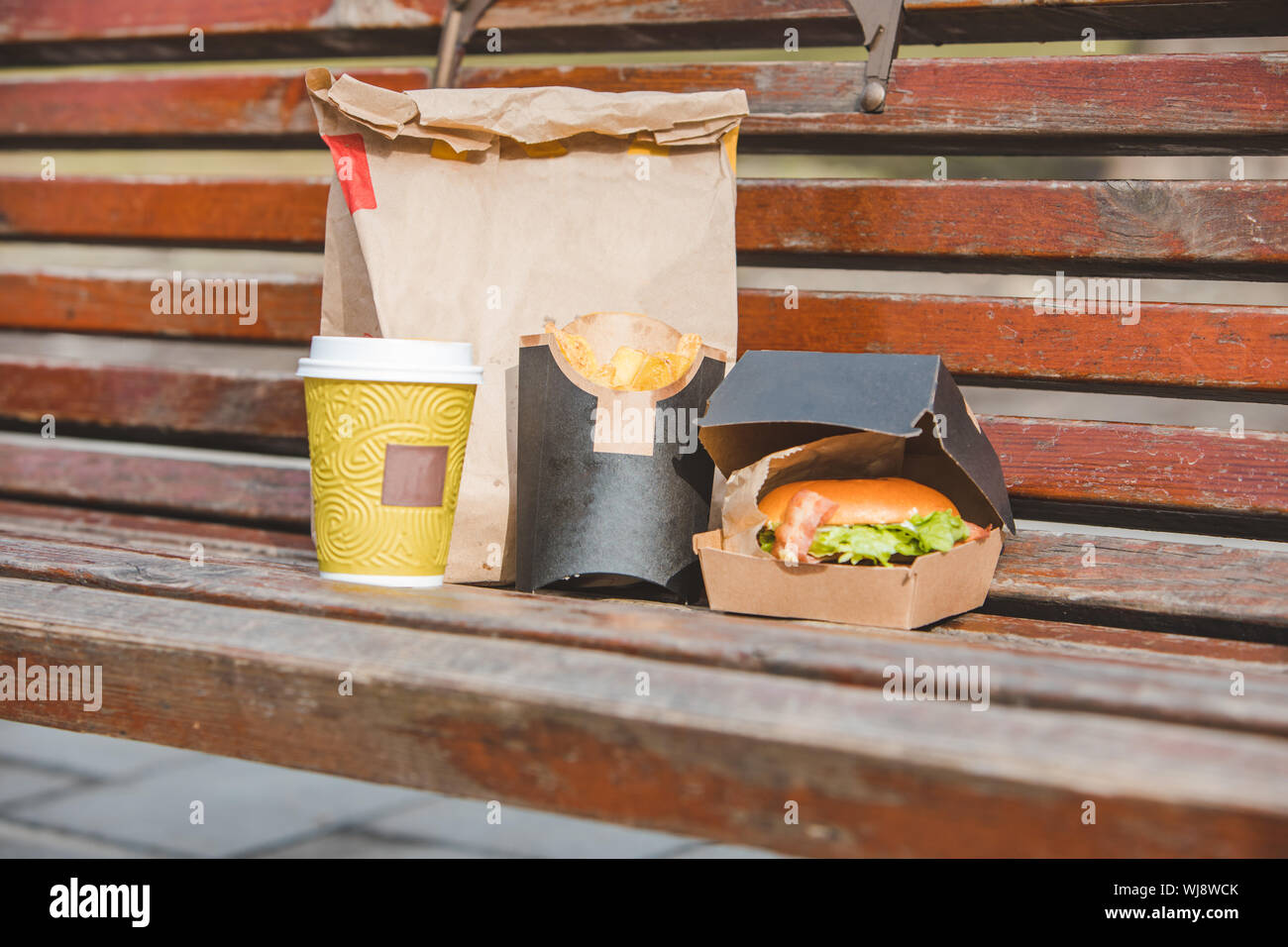 burger in box with fry potatoes coffee cup. fast food. street outdoors ...