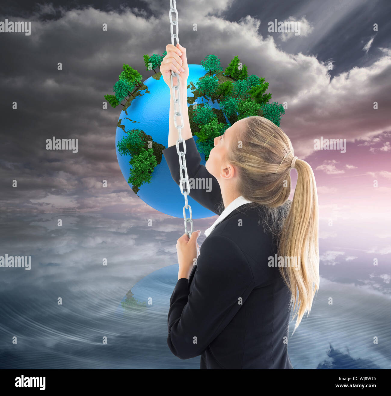 Composite image of blonde businesswoman pulling a chain Stock Photo - Alamy