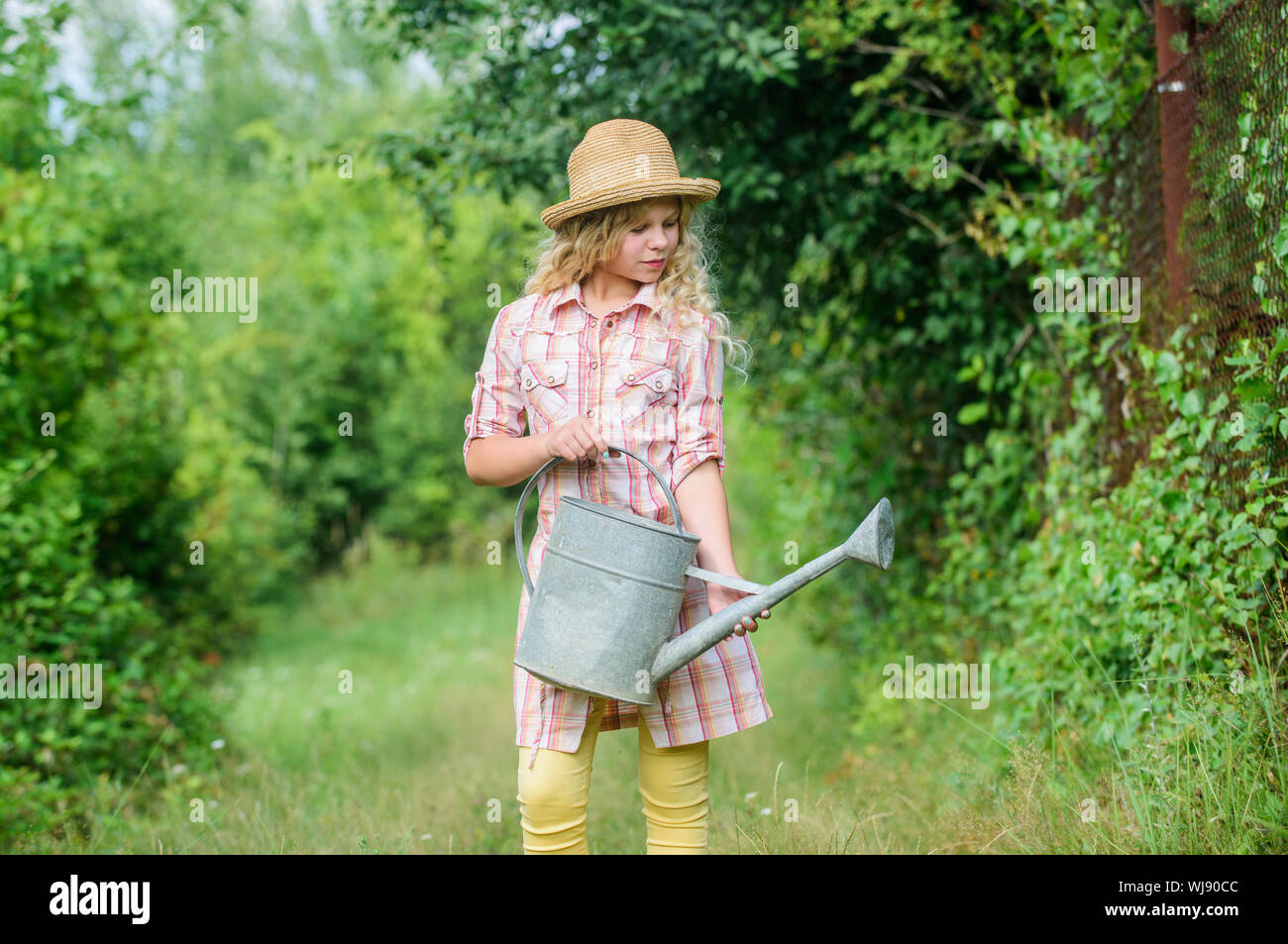 Girl child hold watering can. Spring gardening checklist. Watering ...