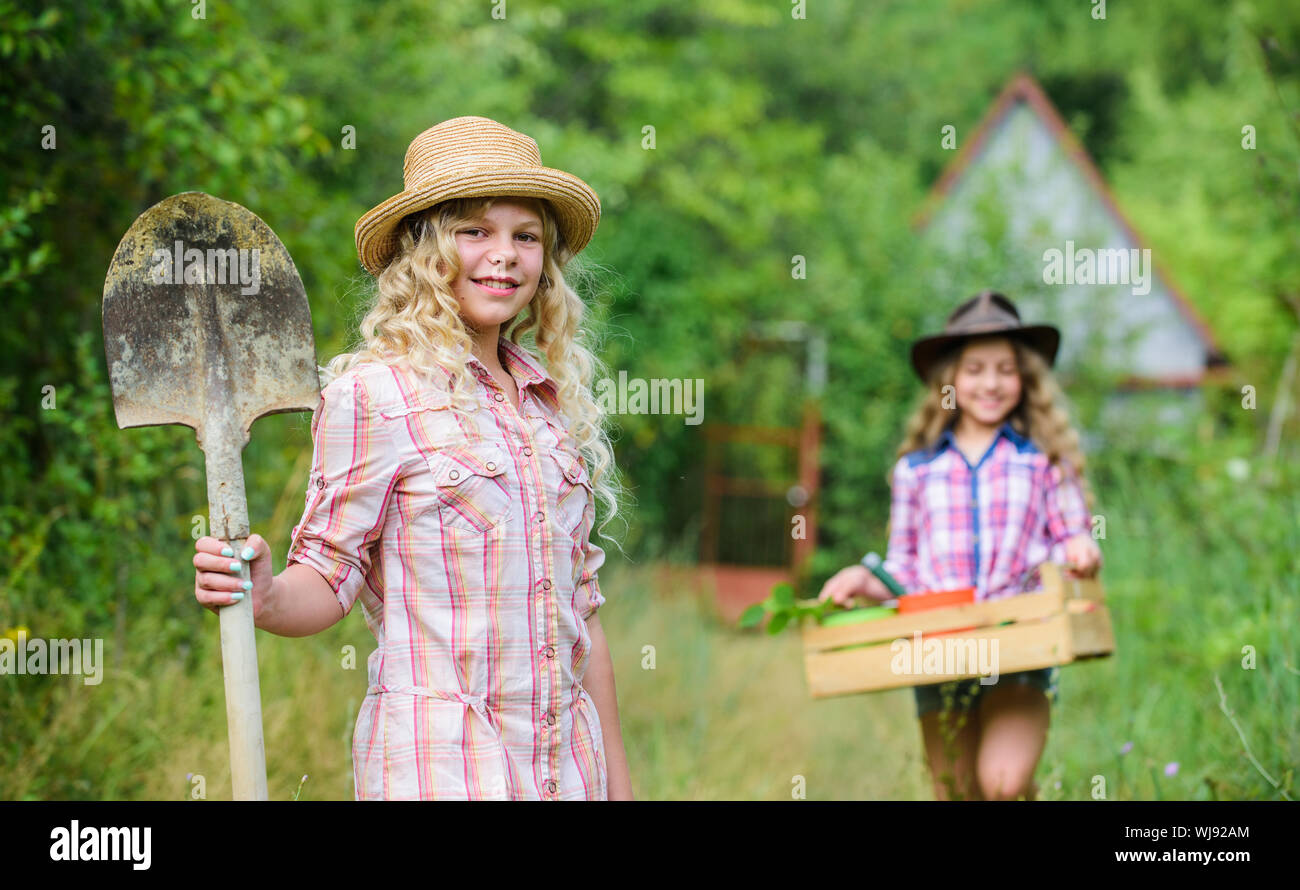 Girls with gardening tools. Summer at countryside. Sisters helping at ...