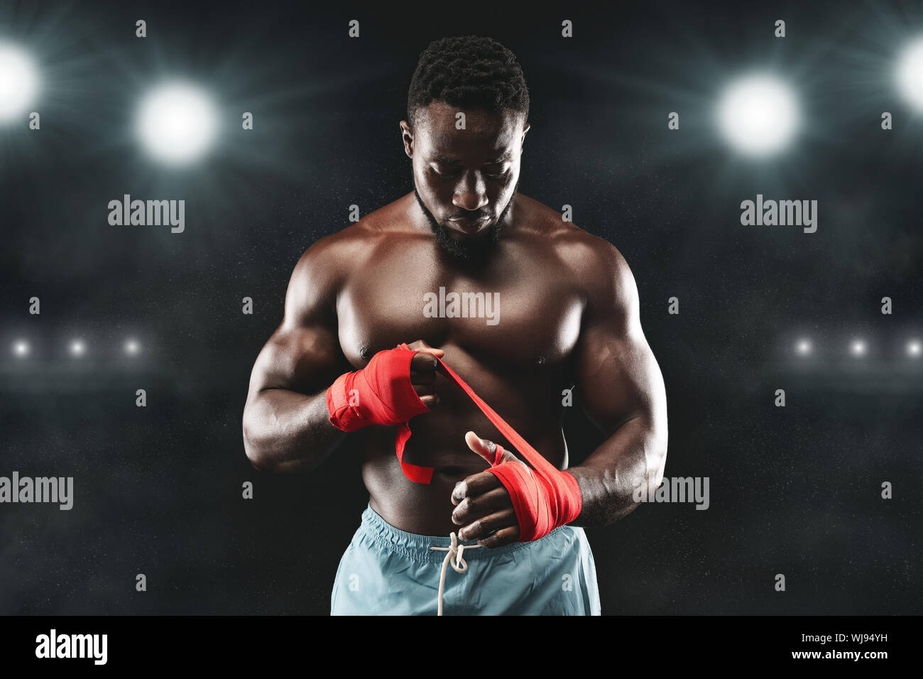Professional black boxer wrapping hands before fight Stock Photo - Alamy