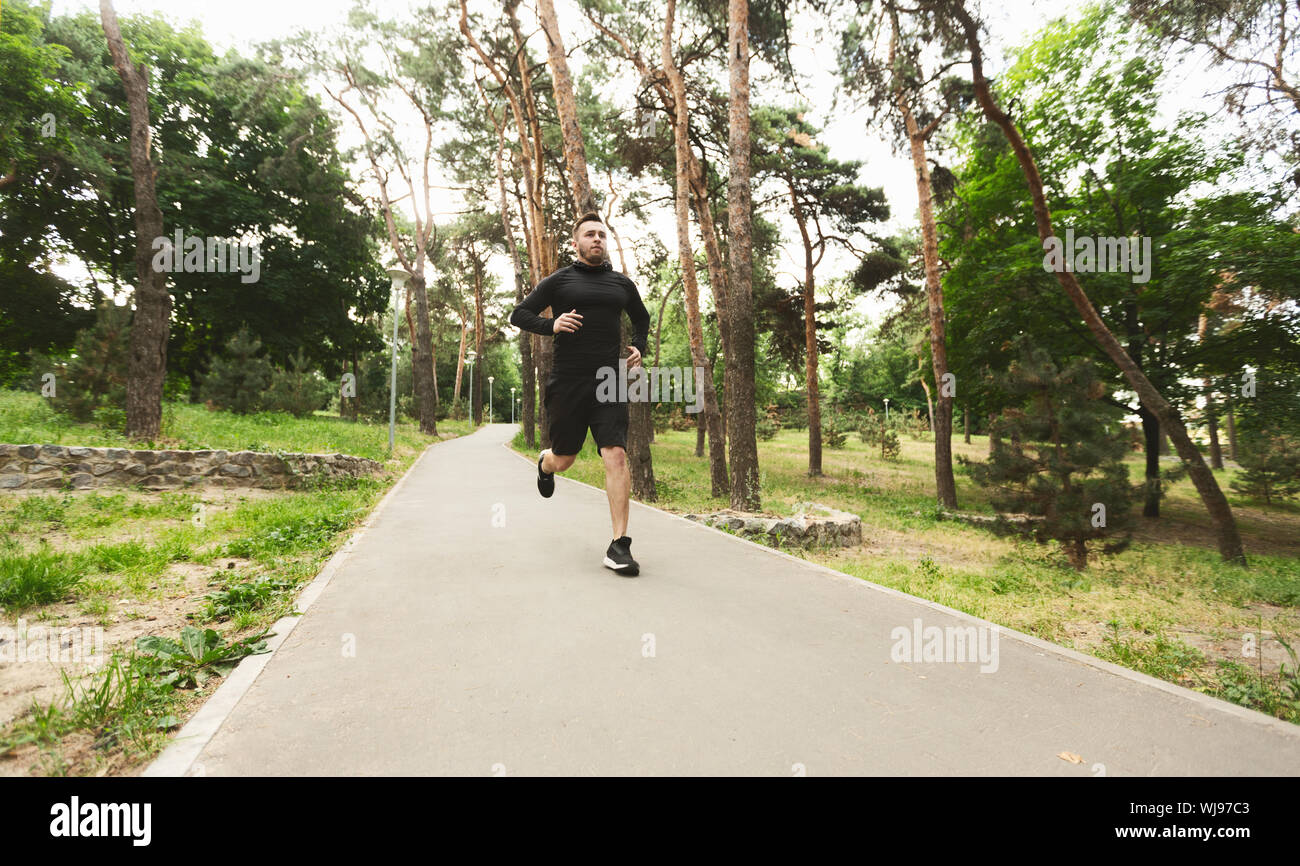 Athletic young male running in park hi-res stock photography and images ...