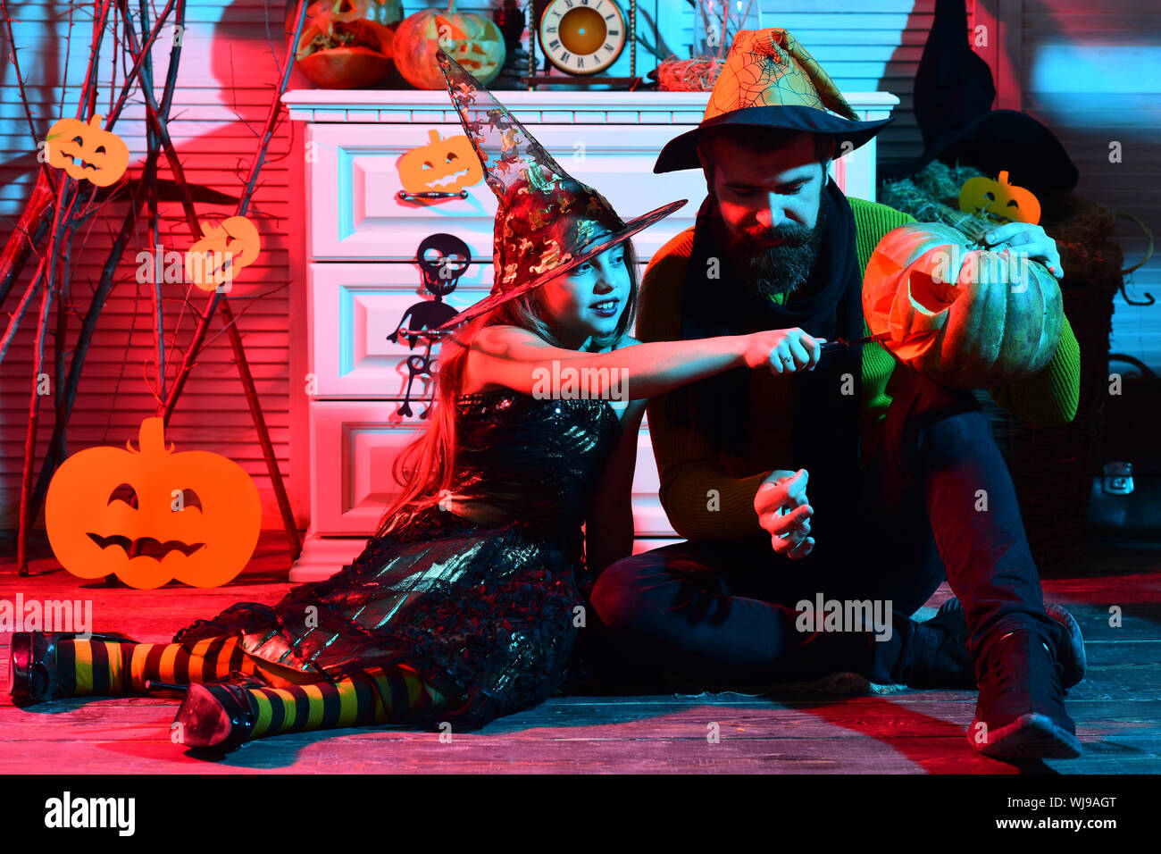 Father and daughter with Halloween decor. Wizard and little witch Stock ...