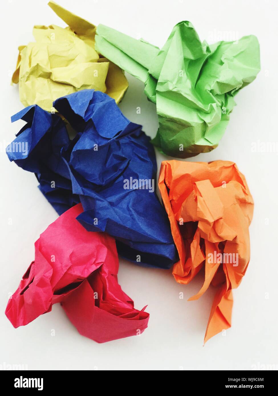 Multi Colored Crumpled Paper Against White Background Stock Photo - Alamy