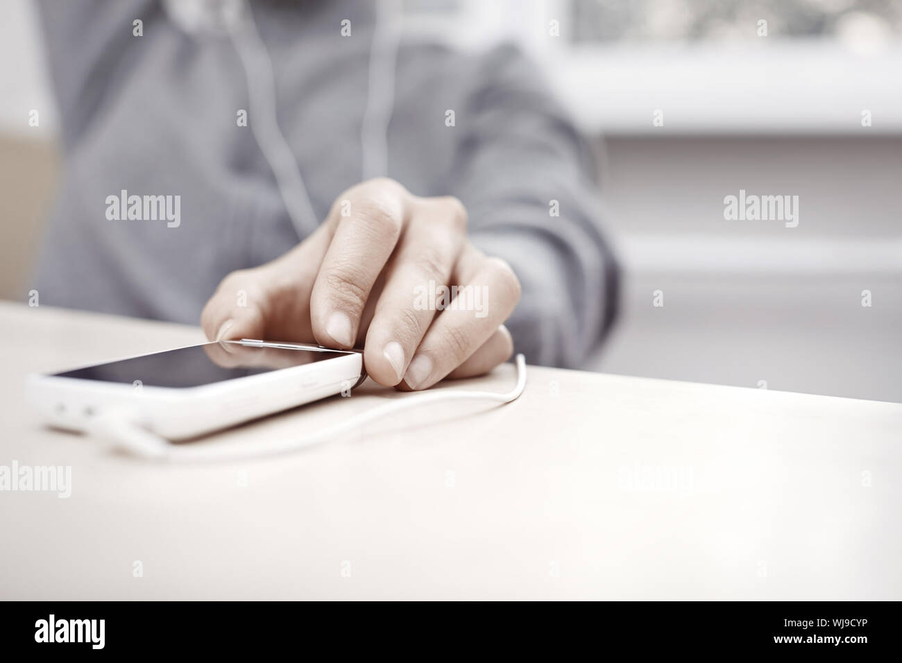 Hand of woman listening music from smartphone Stock Photo - Alamy