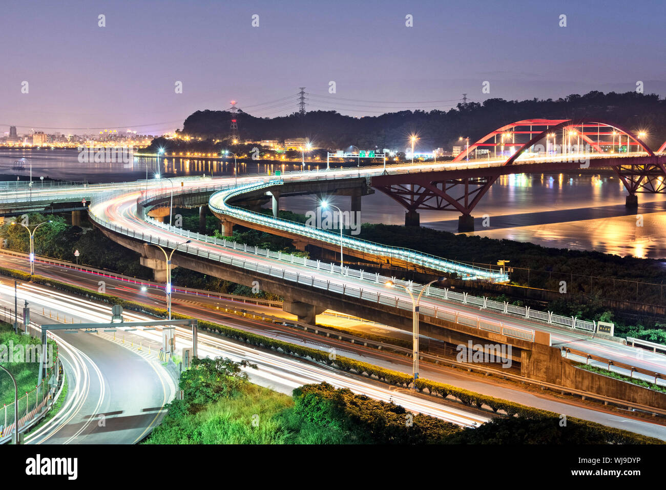 Night scene of cars light at highway and interchange in famous Guandu ...