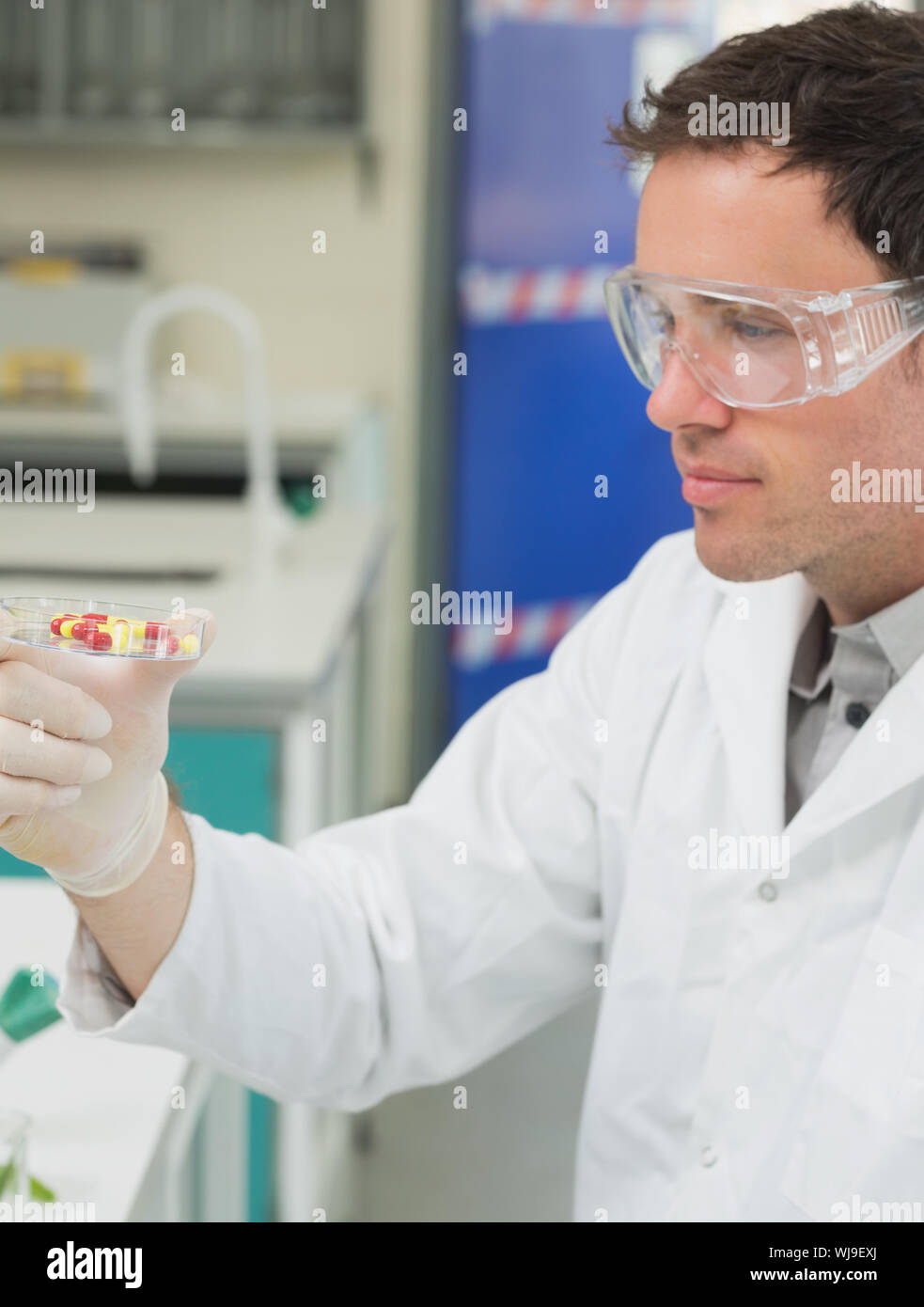 Side view of a male scientist analyzing pills in the laboratory Stock ...