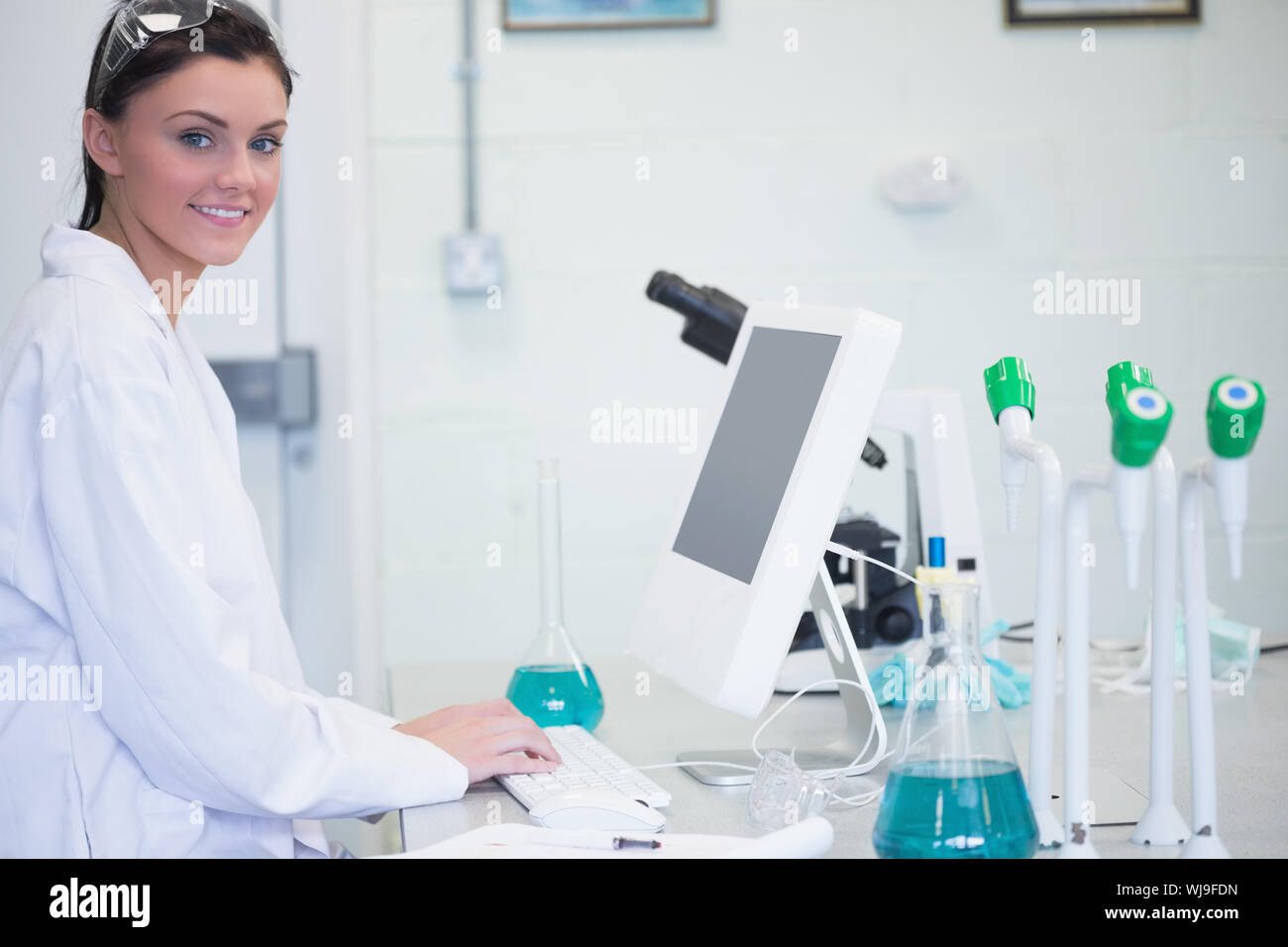 Side view portrait of a young female researcher using computer in the ...