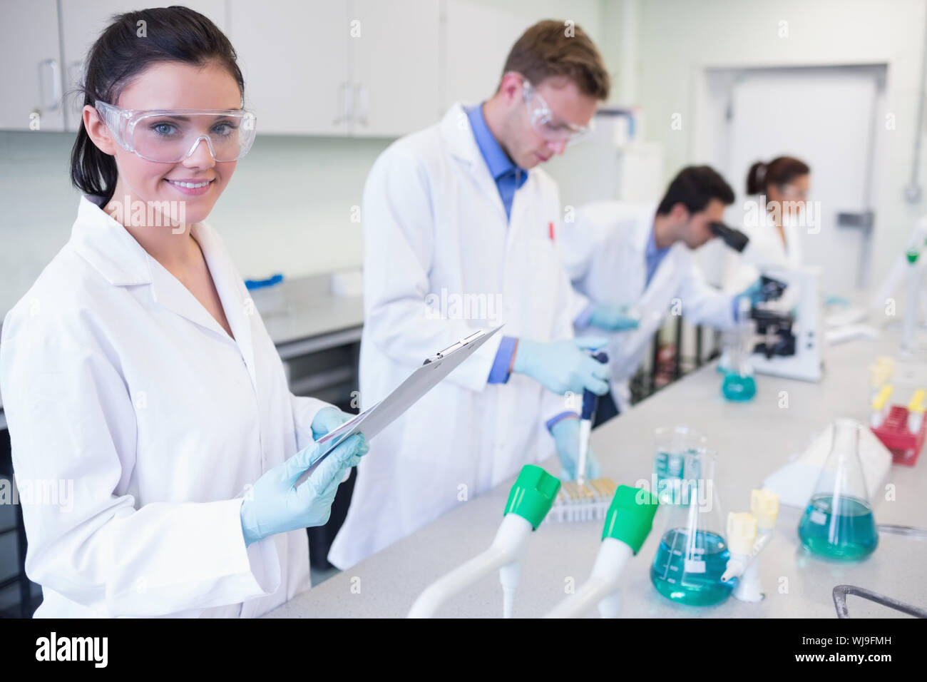 Group of researchers carrying out experiments in the laboratory Stock ...