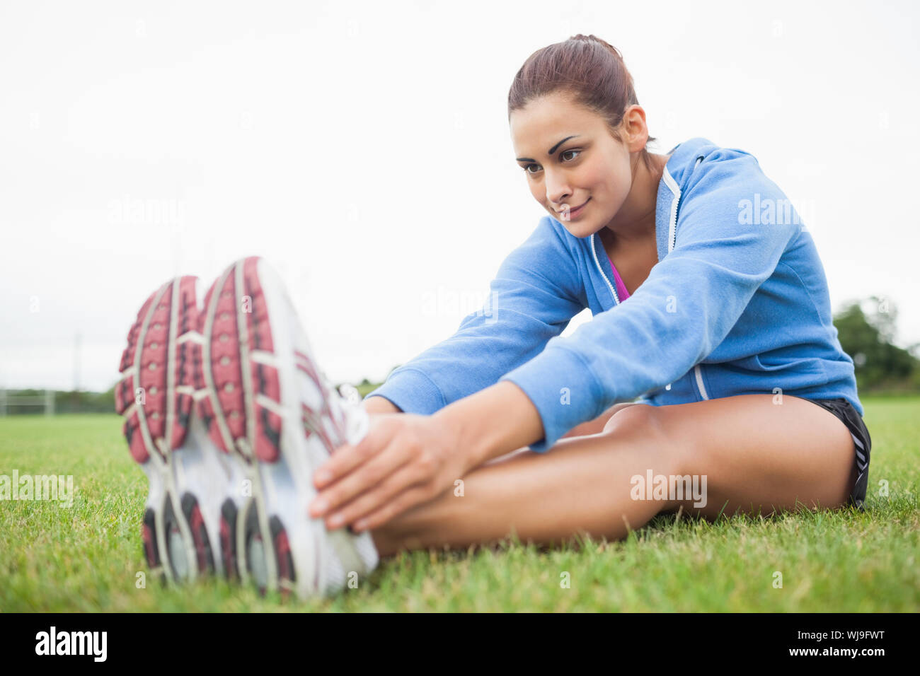 Pretty woman stretching legs sitting hi-res stock photography and ...