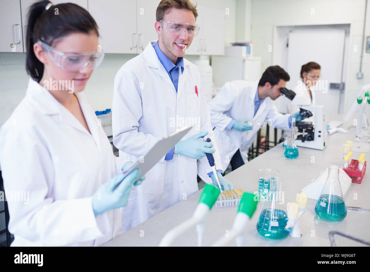 Group of researchers carrying out experiments in the laboratory Stock ...