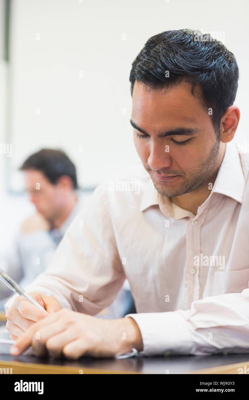 Close-up of a mature student taking notes in lecture in college Stock ...