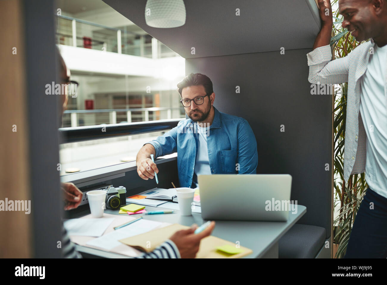 Diverse group of designers working on a project together in a meeting ...