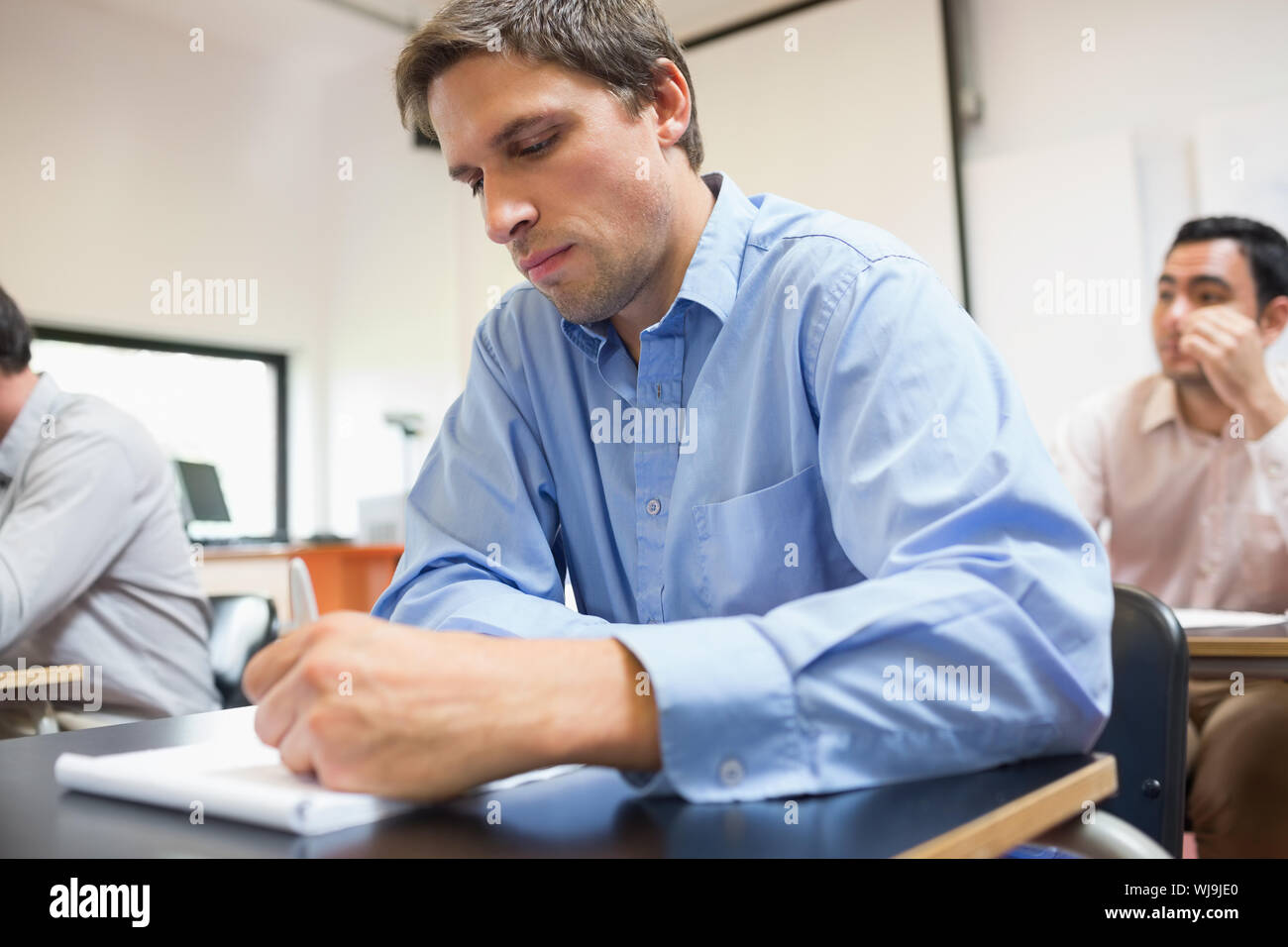 Students taking notes in lecture hi-res stock photography and images ...