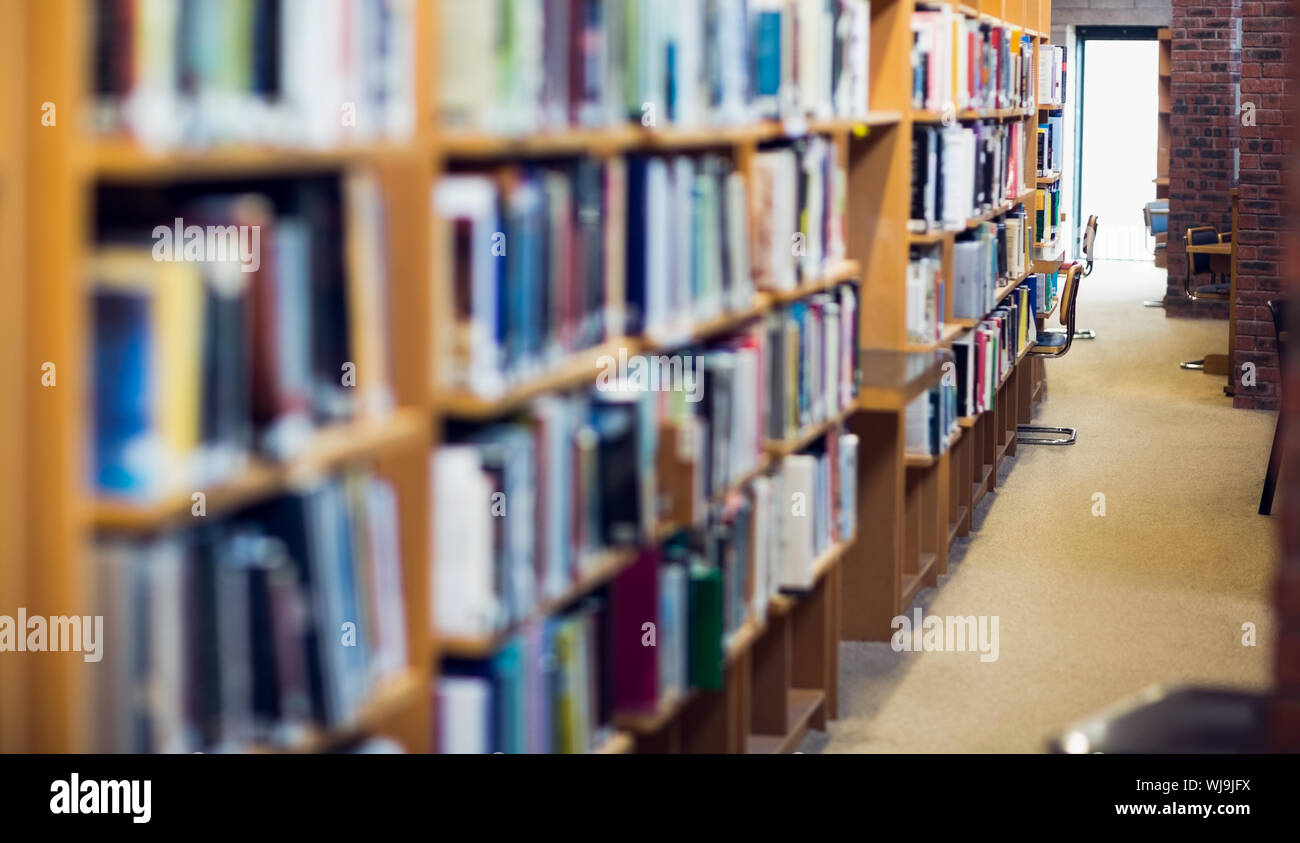 View of a narrow aisle along bookshelves in the college library Stock ...